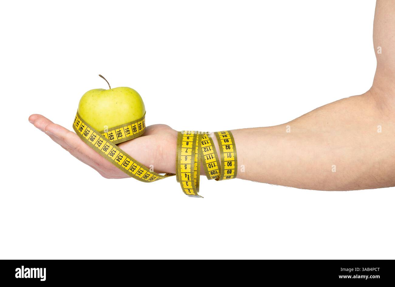 Muscular male arm with green apple and measuring tape isolated on white ...