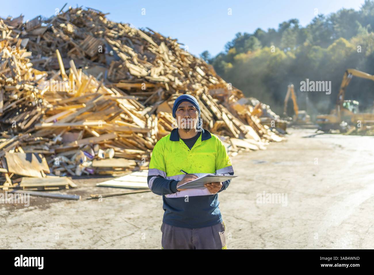 Portrait with copy space of a latin male working managing waste while ...