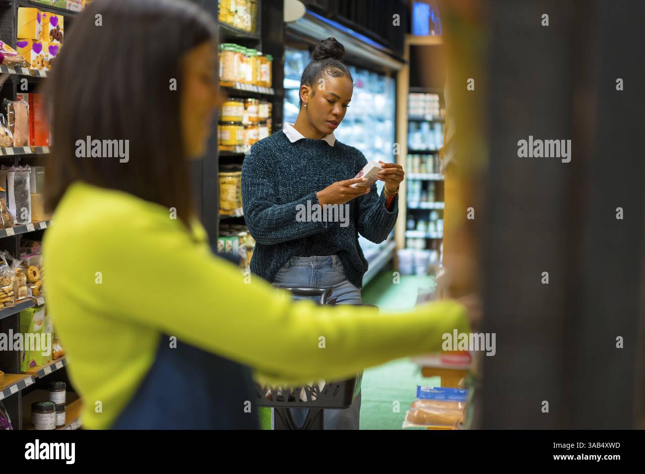 Customer carefully checking ingredients on a product in an organic ...