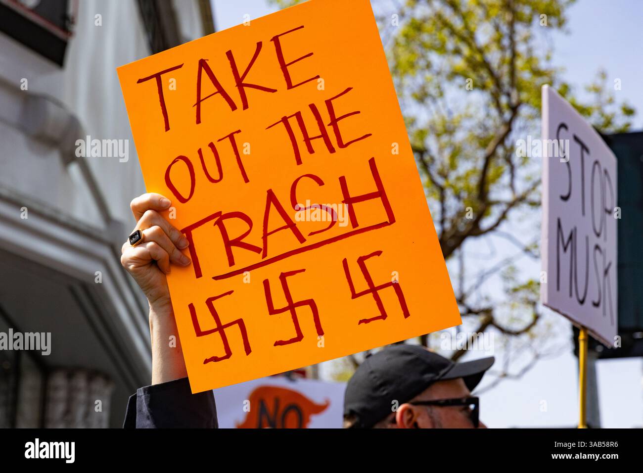 People gather to protest against Tesla CEO Elon Musk outside a Tesla ...