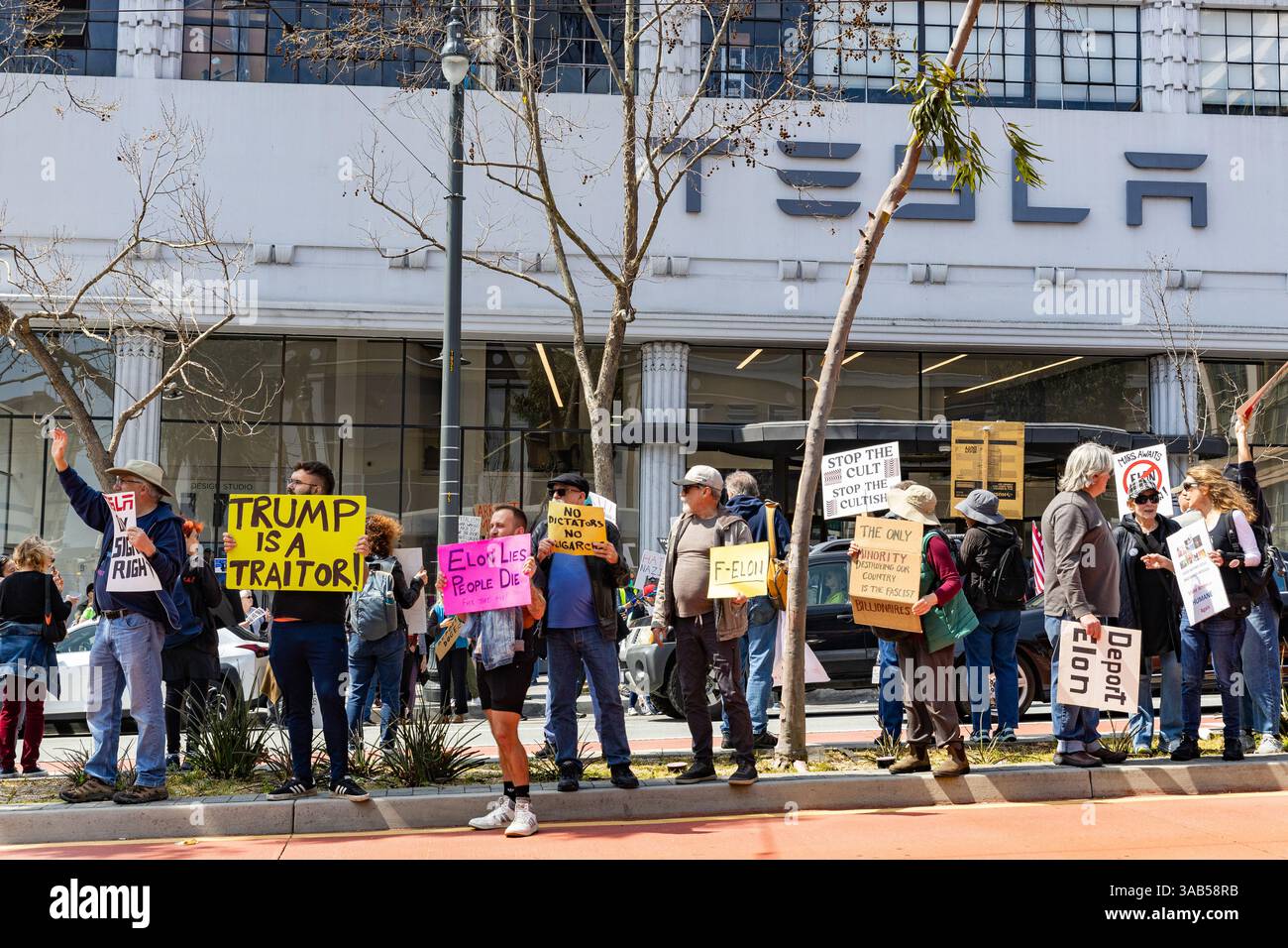 People gather to protest against Tesla CEO Elon Musk outside a Tesla ...