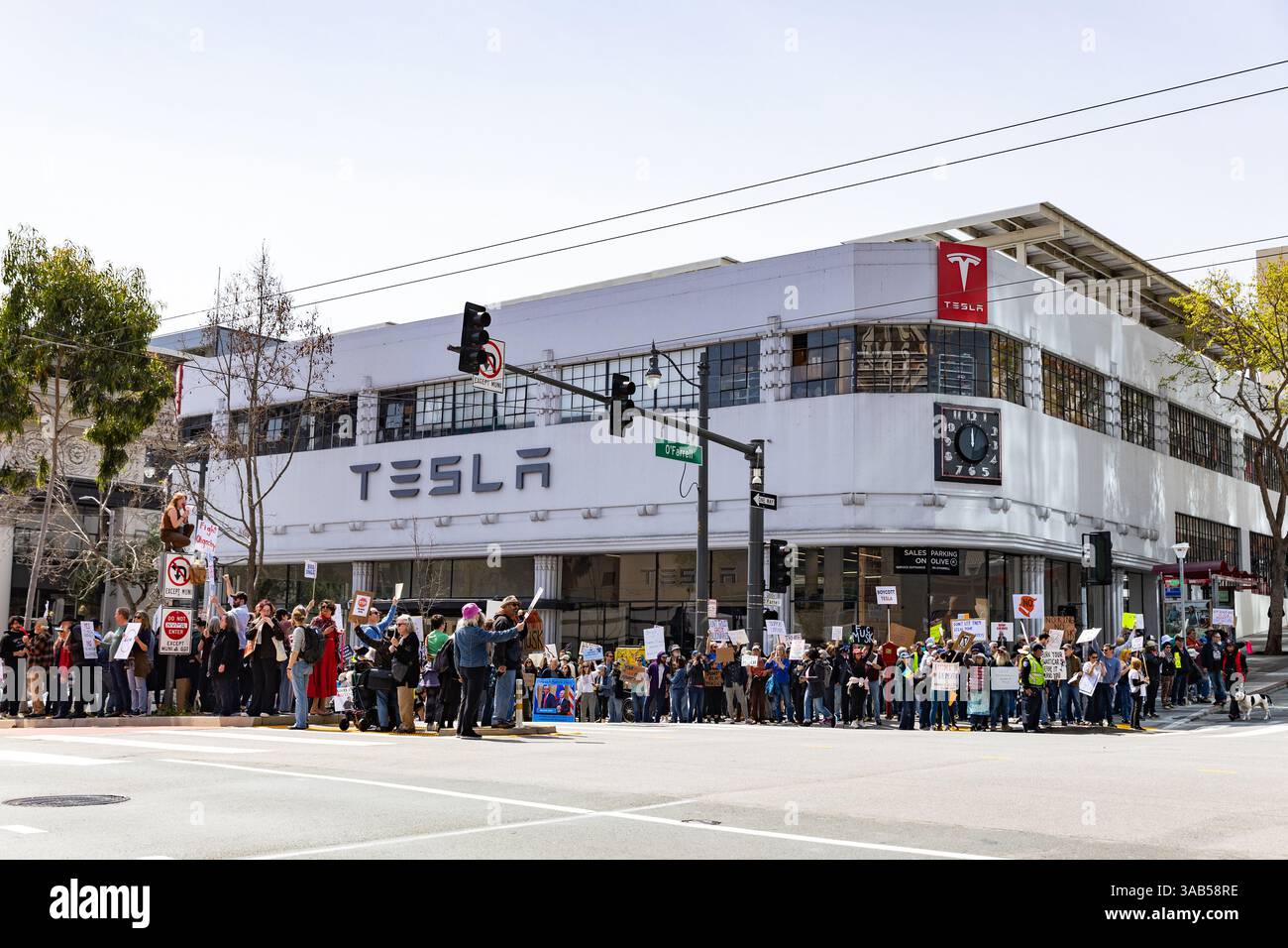 People gather to protest against Tesla CEO Elon Musk outside a Tesla ...