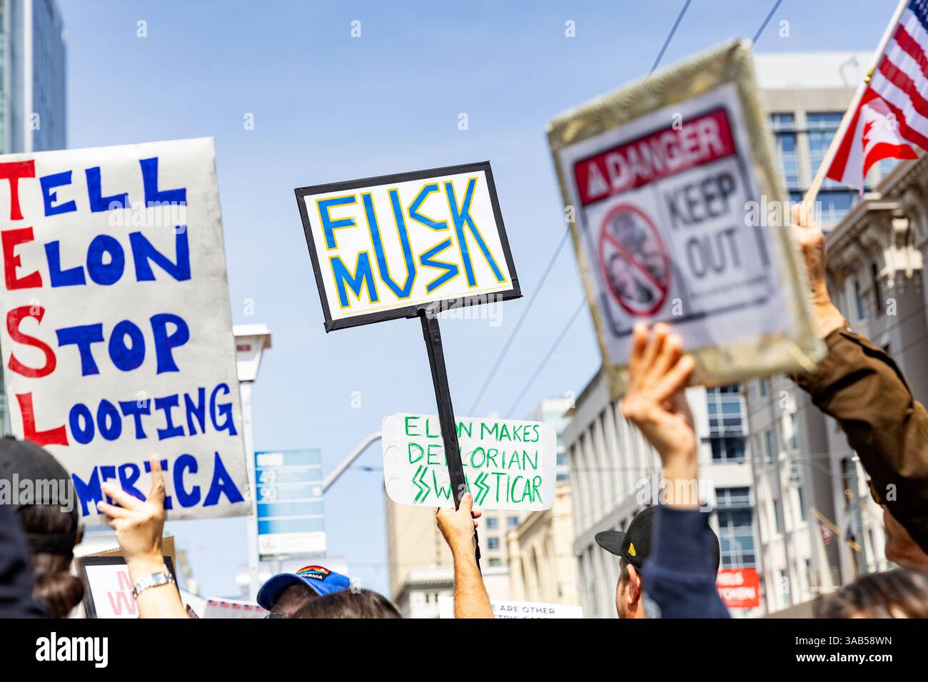 People gather to protest against Tesla CEO Elon Musk outside a Tesla ...