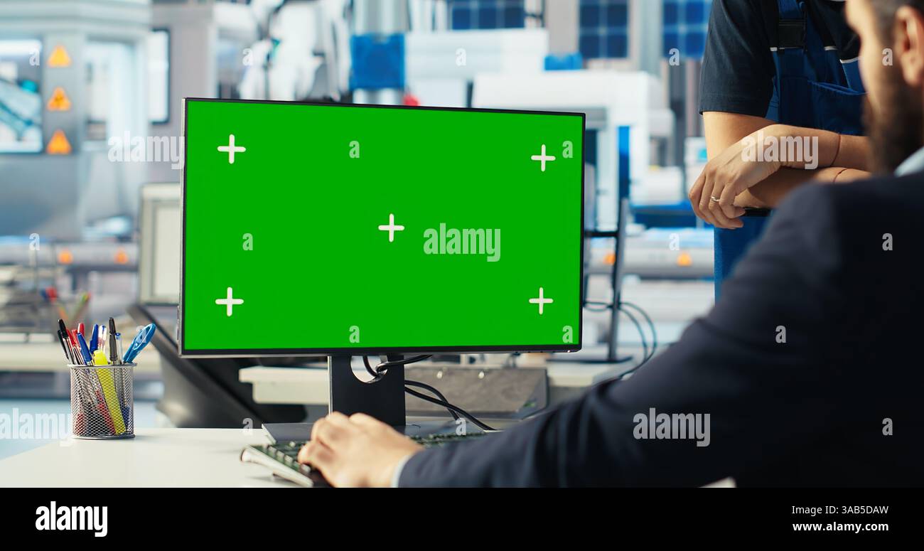 Photovoltaics factory staff member analyzing data on isolated screen PC ...