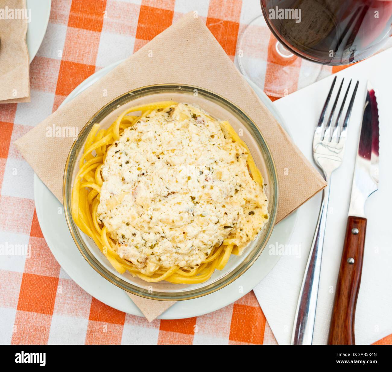 Pasta carbonara - boiled long spaghetti with thick sauce based on cream ...