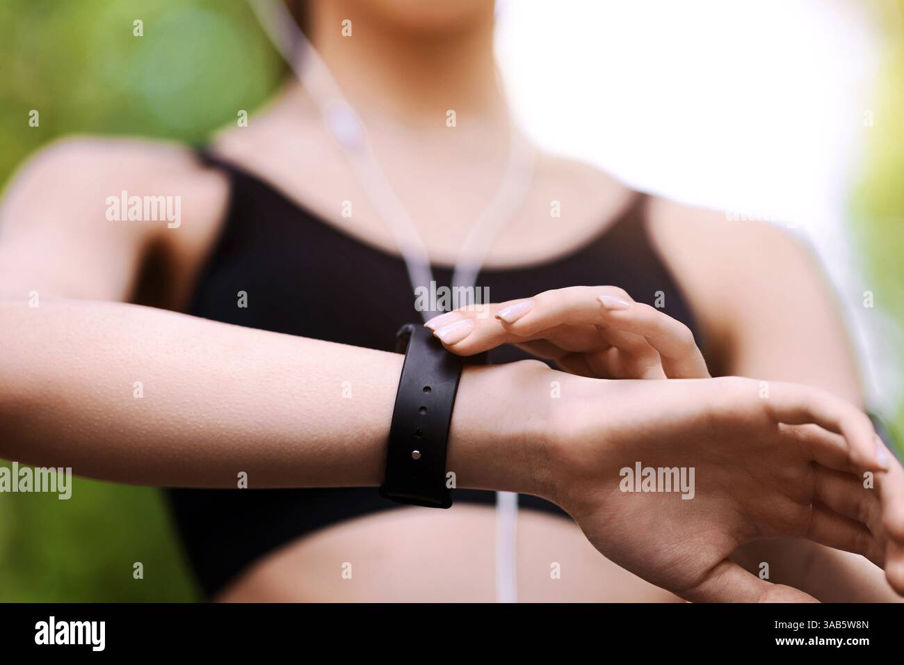 Gadgets For Sport. Female athlete using smartwatch outdoors to track ...