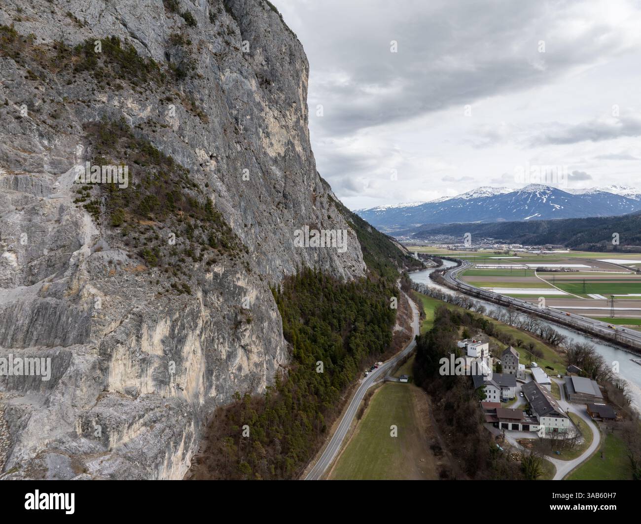 Excavation Site on Cliff in Austrian Alps with Town Below Stock Photo ...