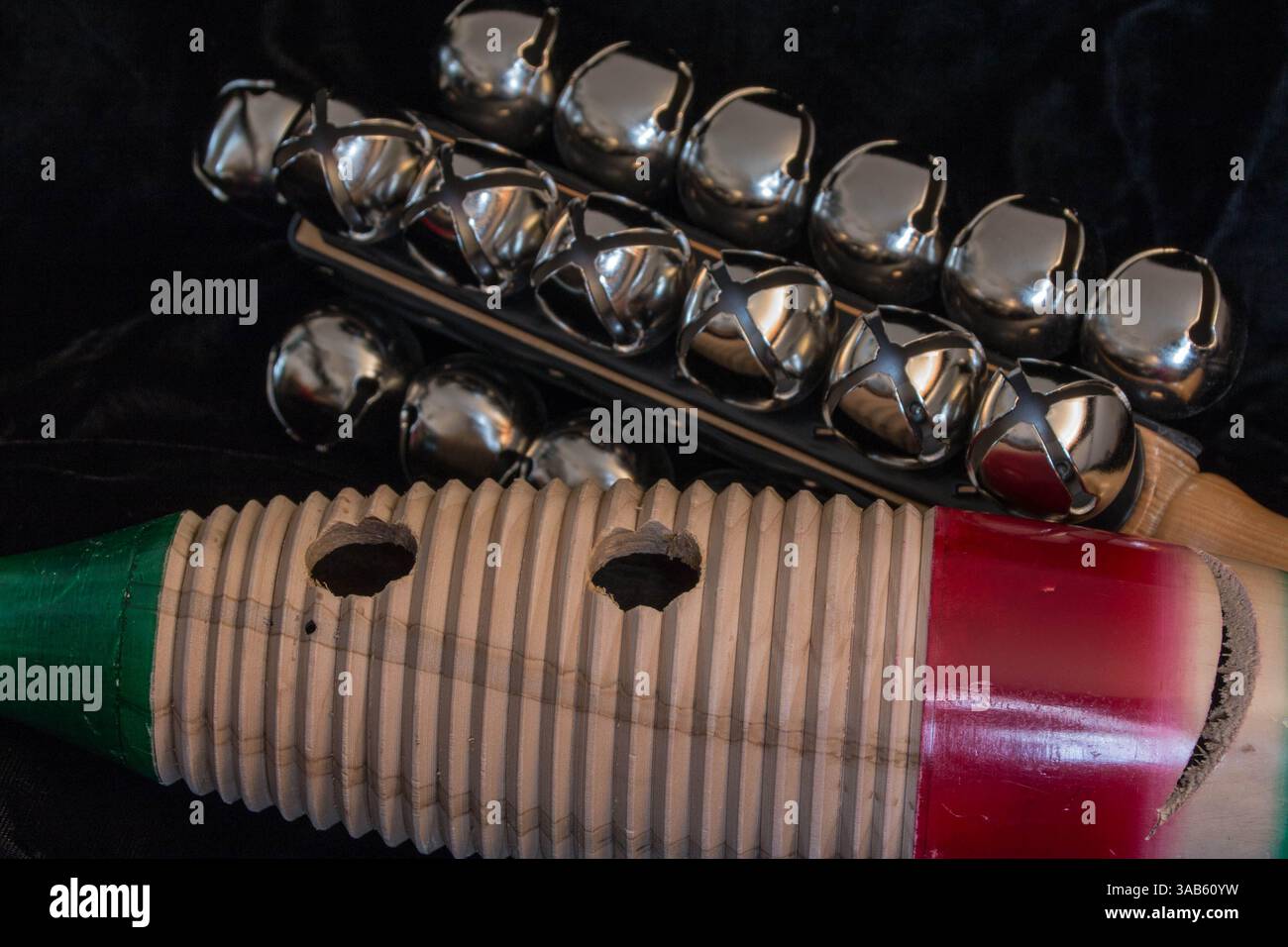 Orchestral percussion instruments guiro and sleigh bells on black background Stock Photo - Alamy