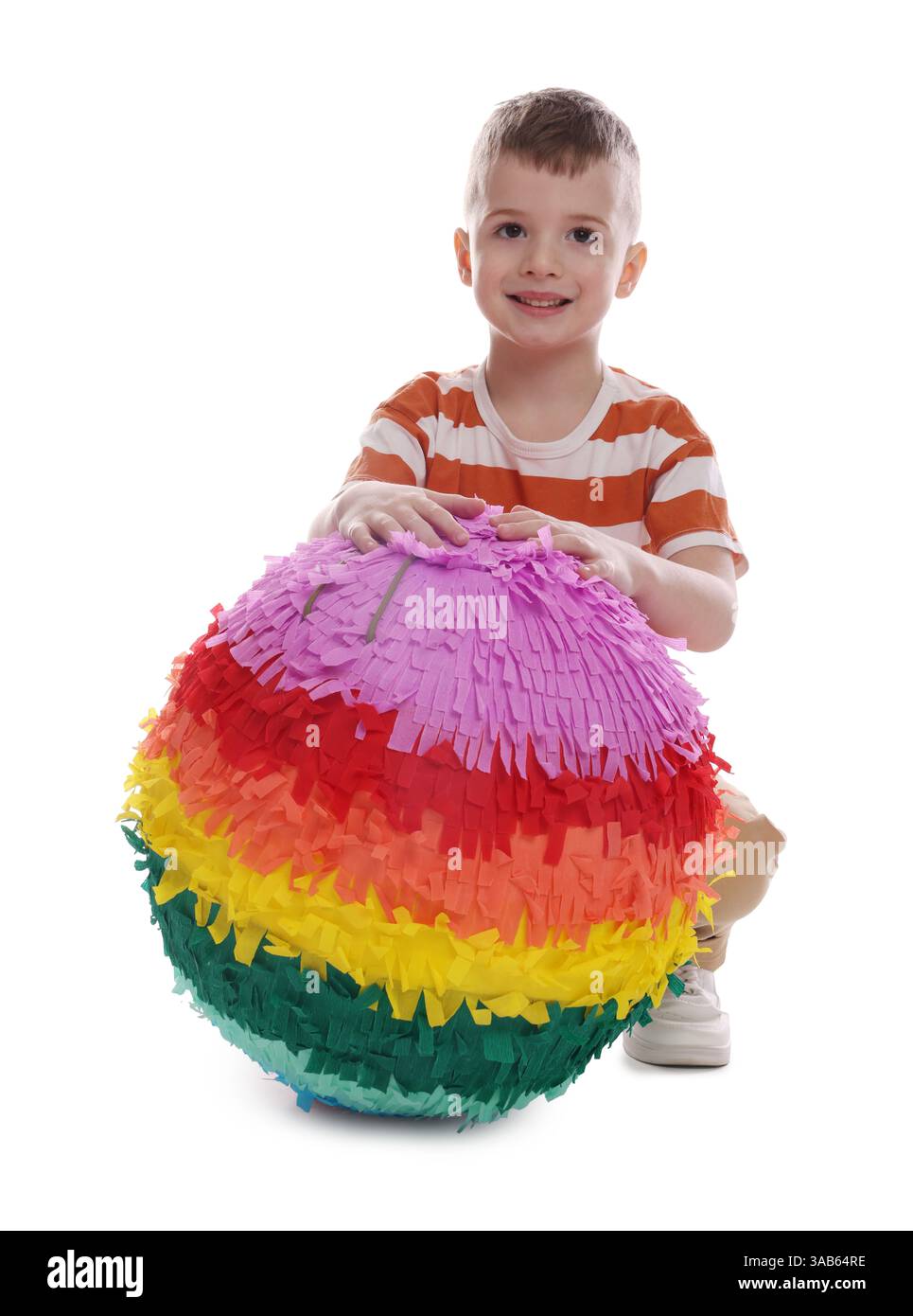 Happy boy with colorful pinata on white background Stock Photo - Alamy