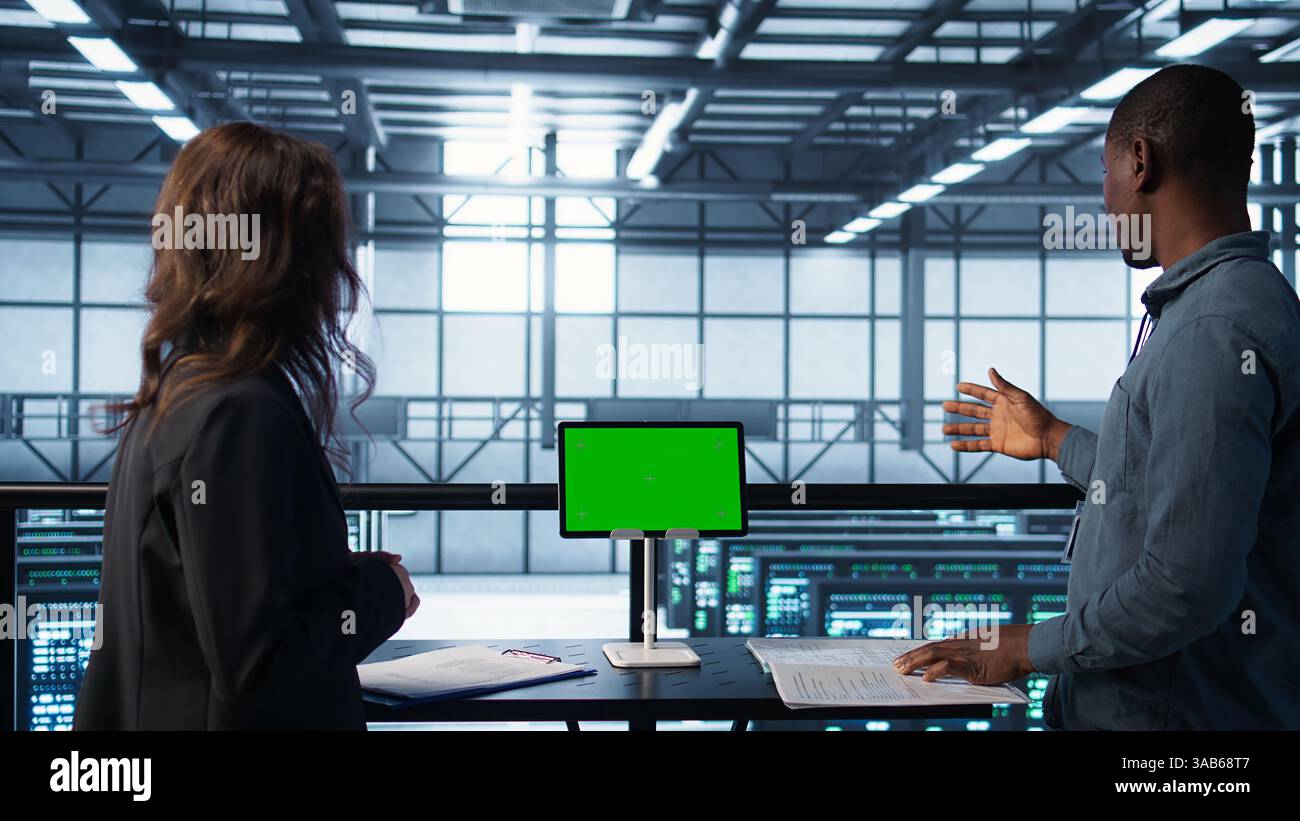 Data Center Team Using Mockup Green Screen Tablet Reviewing Paperwork Files And Security