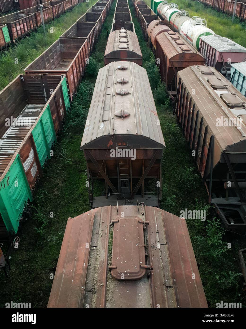 Aerial view of abandoned railway station: train tracks and rusty ...