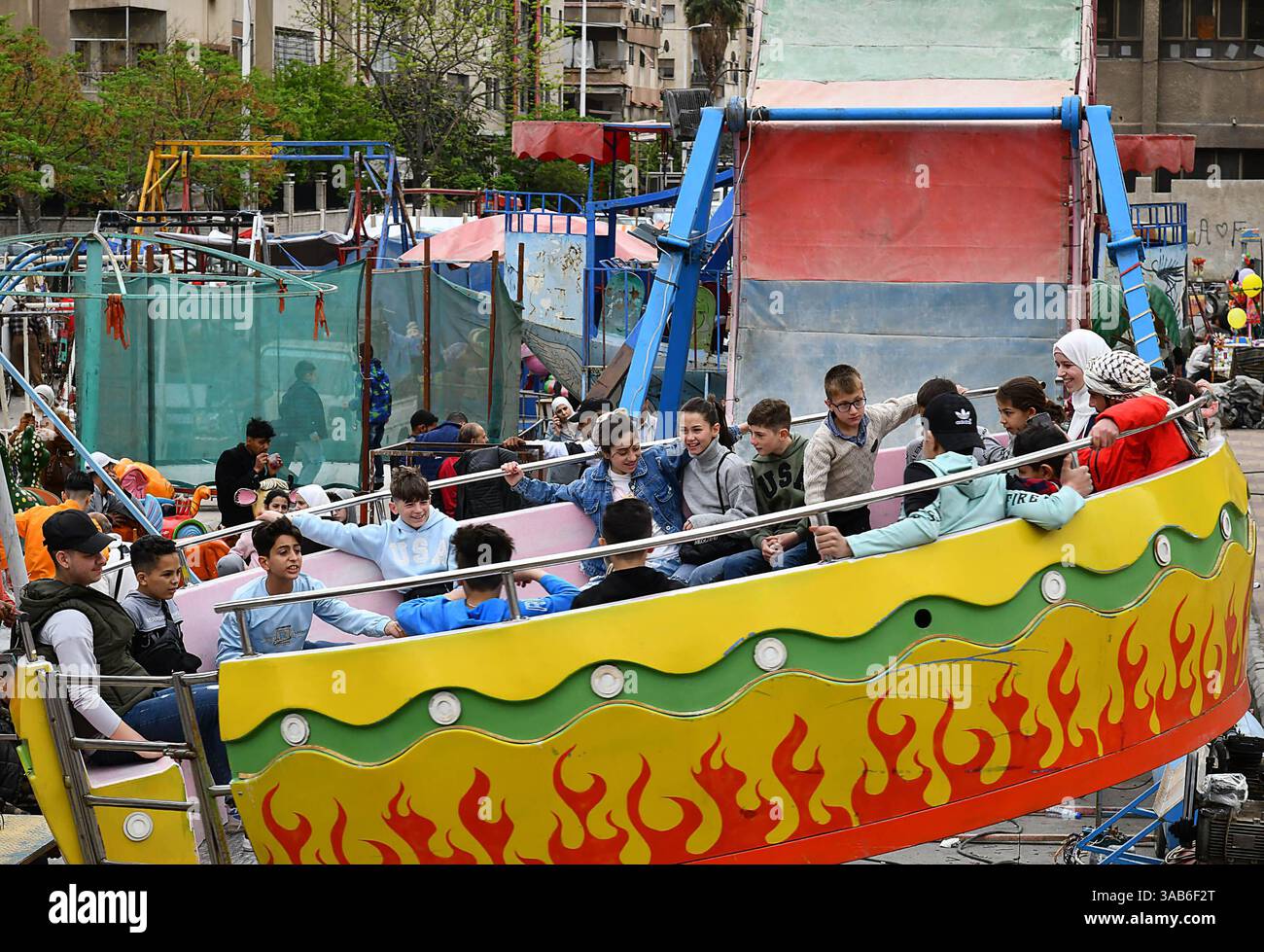 Damascus, Syria. 1st Apr, 2025. People enjoy themselves at a park ...