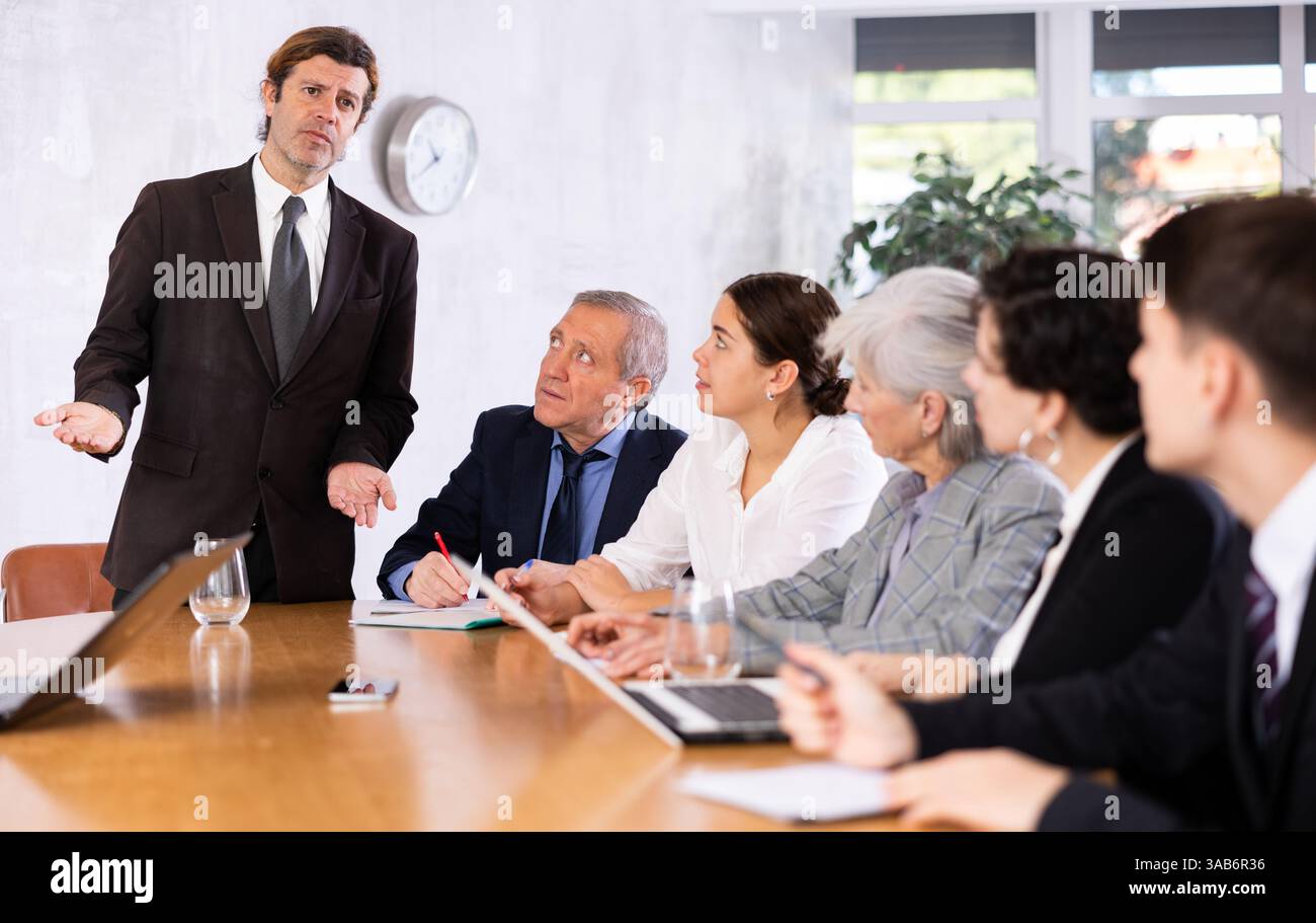 Furious male boss yelling at office colleagues of different ages taking ...