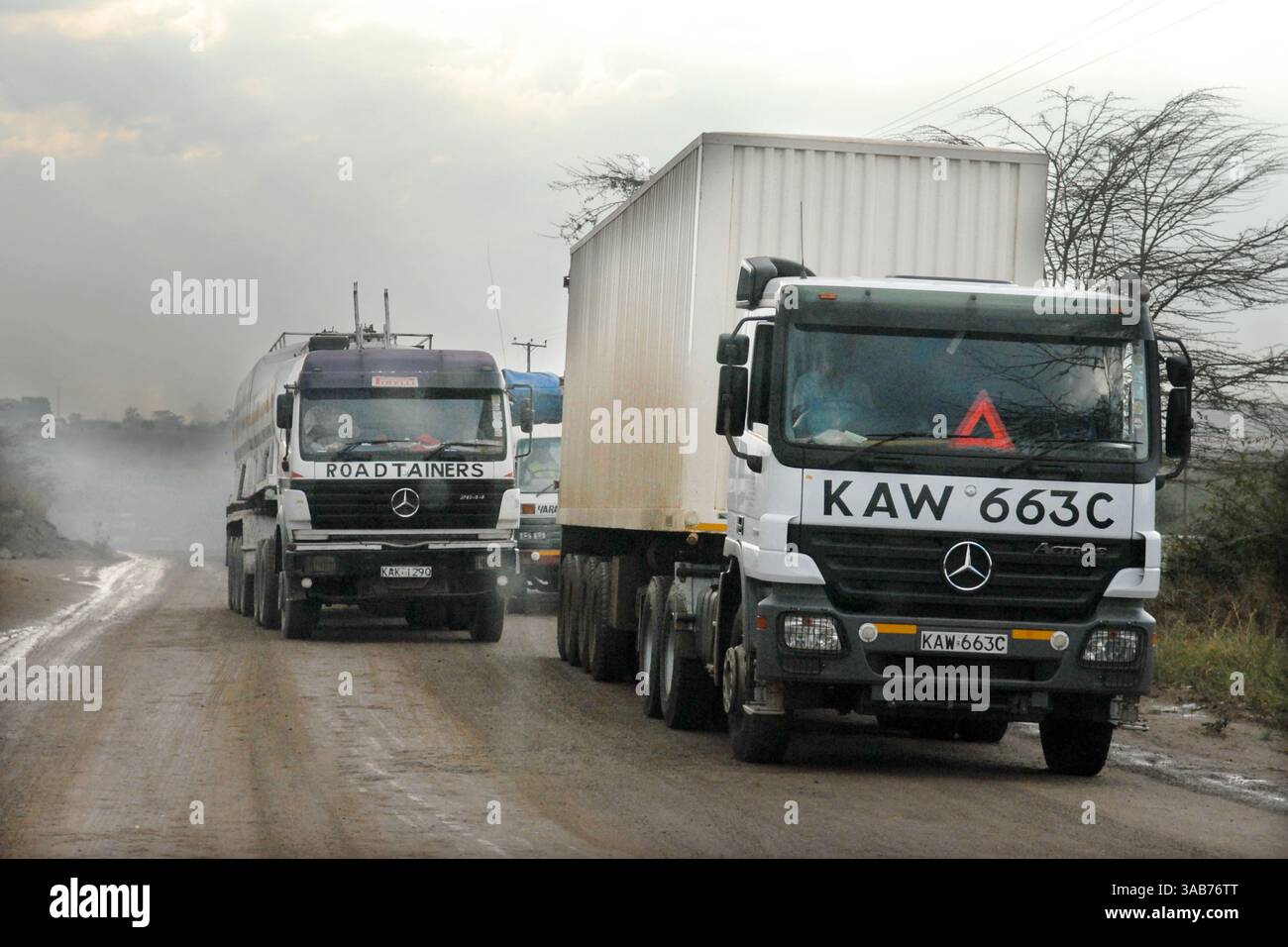 Large and small vehicles fight for road space on the dangerous mud ...
