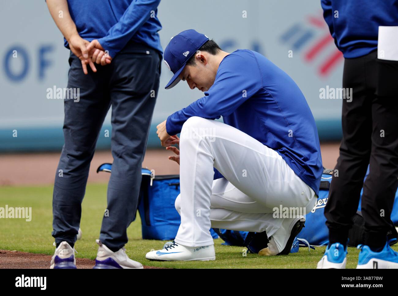 Los Angeles Dodgers' Roki Sasaki takes a break after throwing in the ...