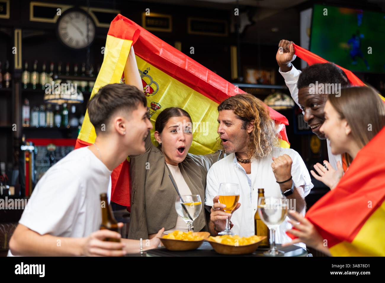 Group of excited Spanish football fans celebrating victory of favorite ...