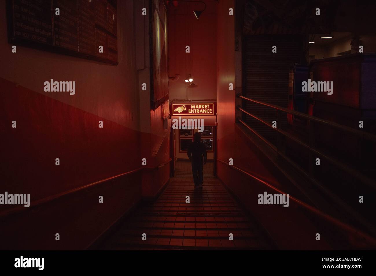 Mysterious person walking down a hall In Pike Place Stock Photo - Alamy