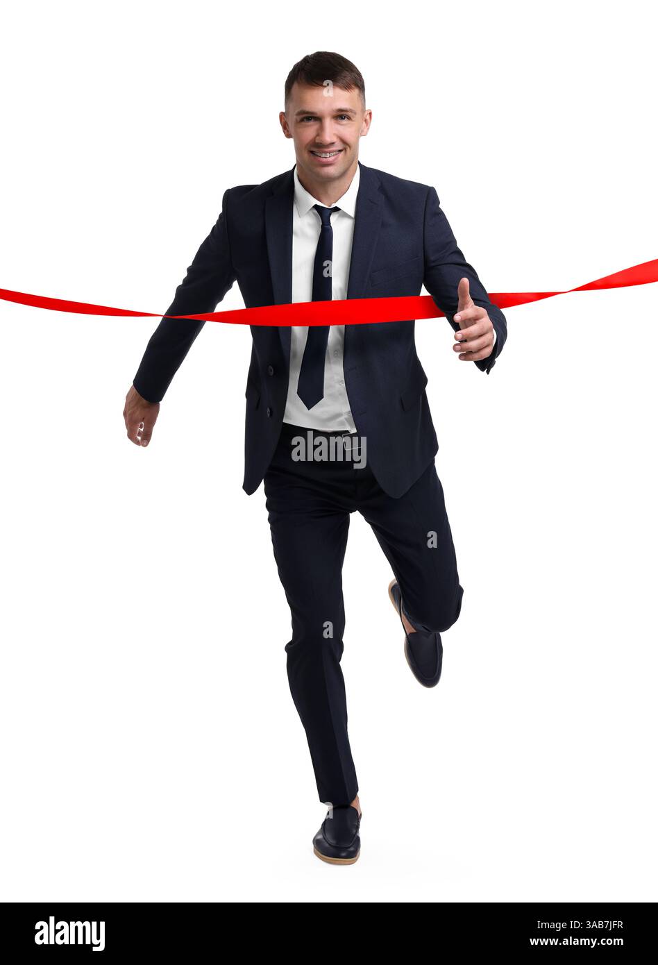 Happy businessman crossing red finish line ribbon on white background ...