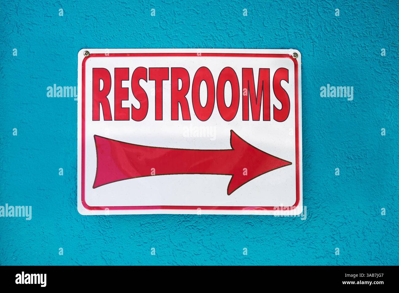 Restroom sign with arrow pointing right, red letters and arrow on white ...