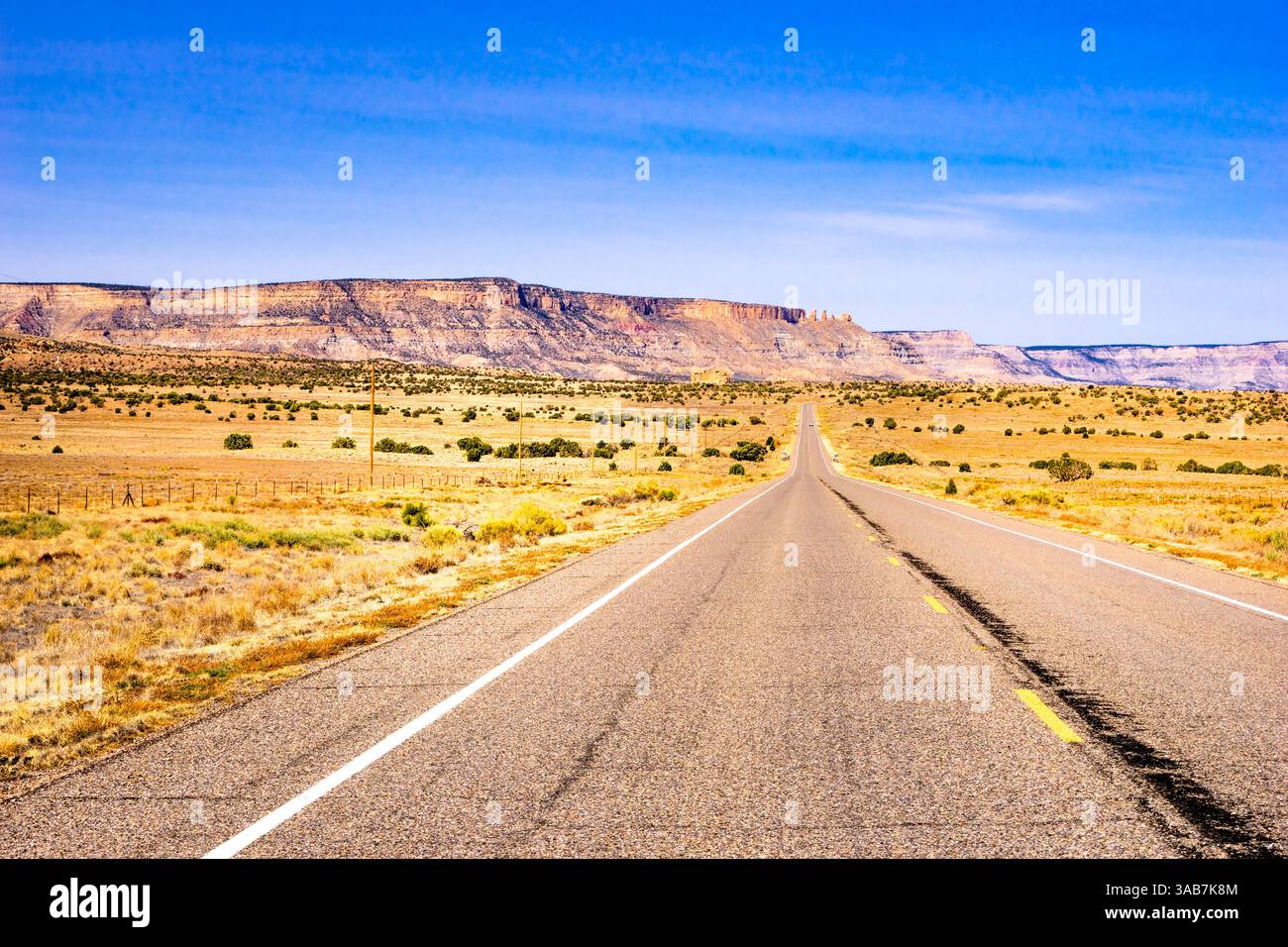 The highway 59 Novajo service route leading to rough rock formation ...