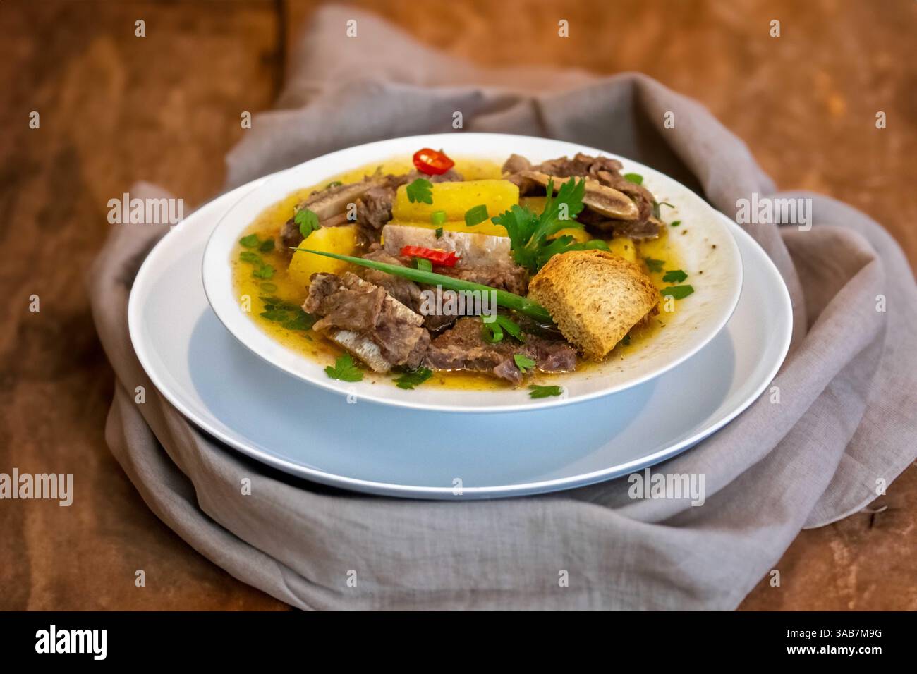 Traditional rustic Brazilian soup known as vaca atolada, prepared with ...