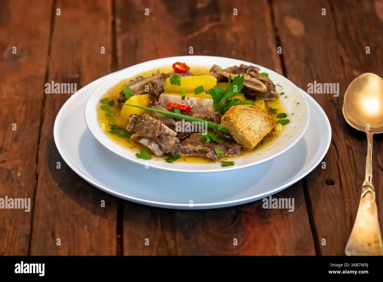 Traditional rustic Brazilian soup known as vaca atolada, prepared with ...