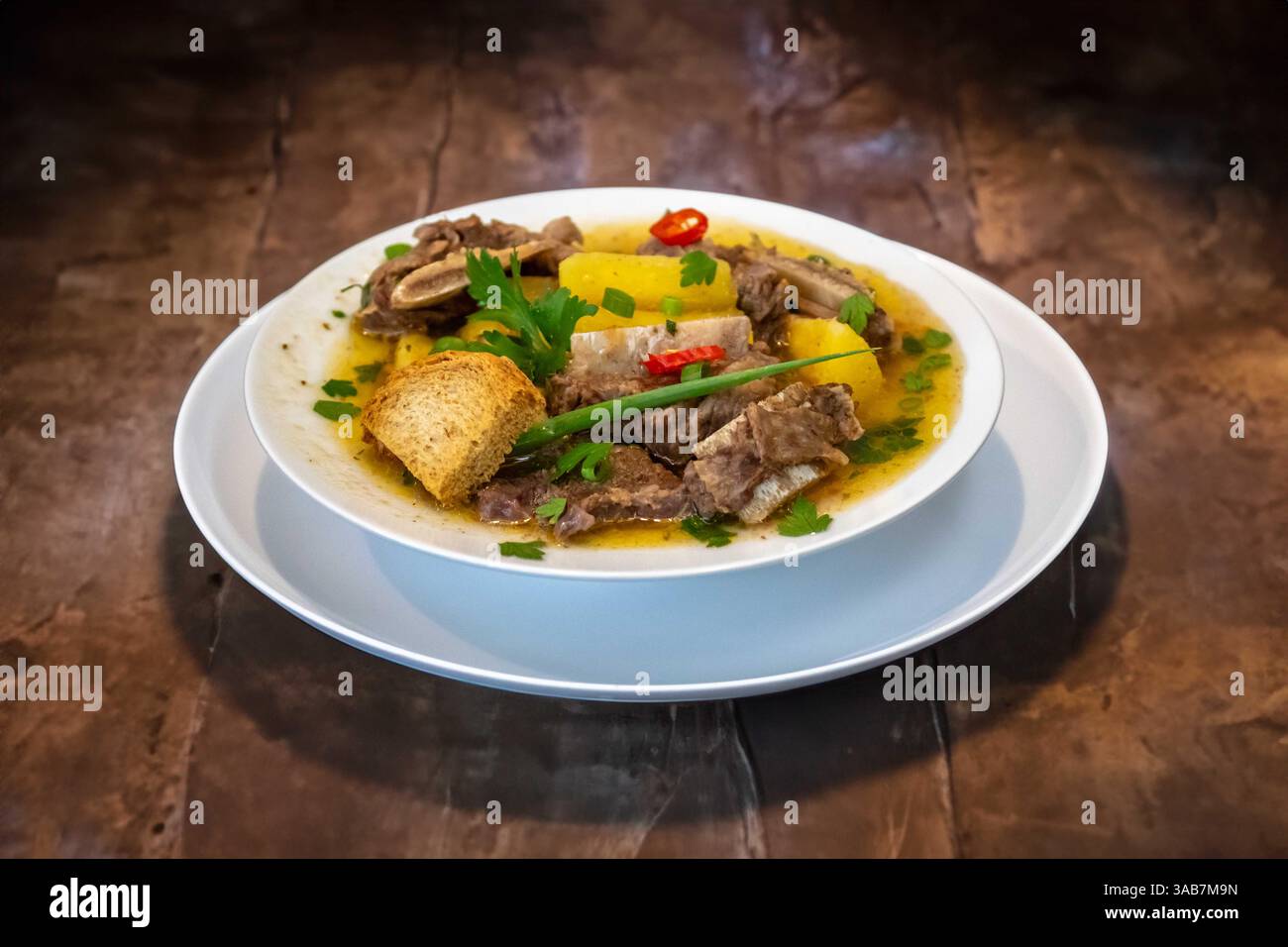 Traditional rustic Brazilian soup known as vaca atolada, prepared with ...