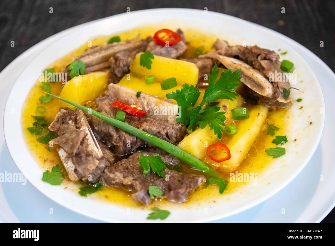 Traditional rustic Brazilian soup known as vaca atolada, prepared with ...