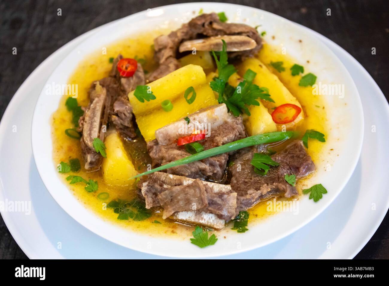 Traditional rustic Brazilian soup known as vaca atolada, prepared with ...