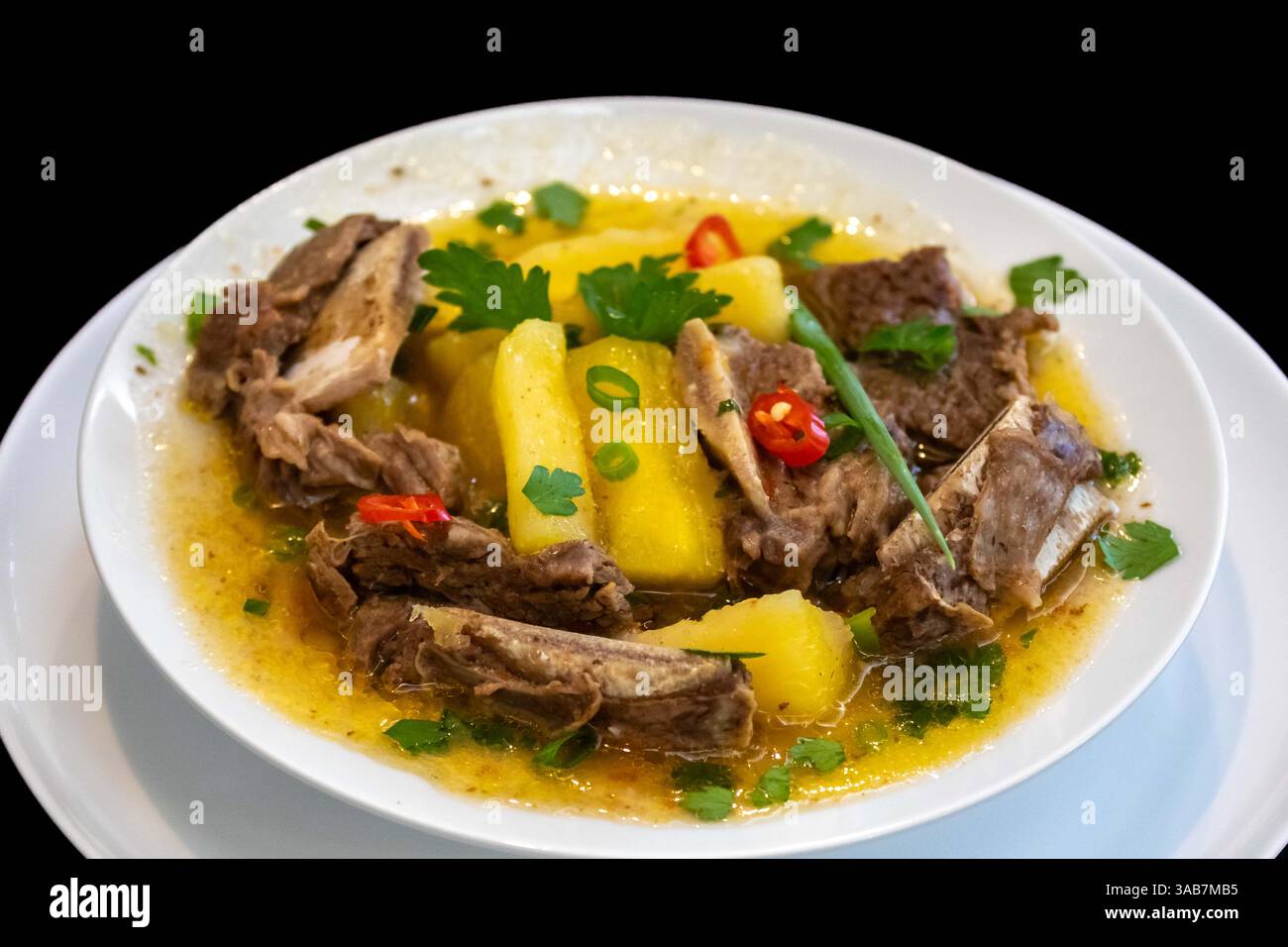 Traditional rustic Brazilian soup known as vaca atolada, prepared with ...