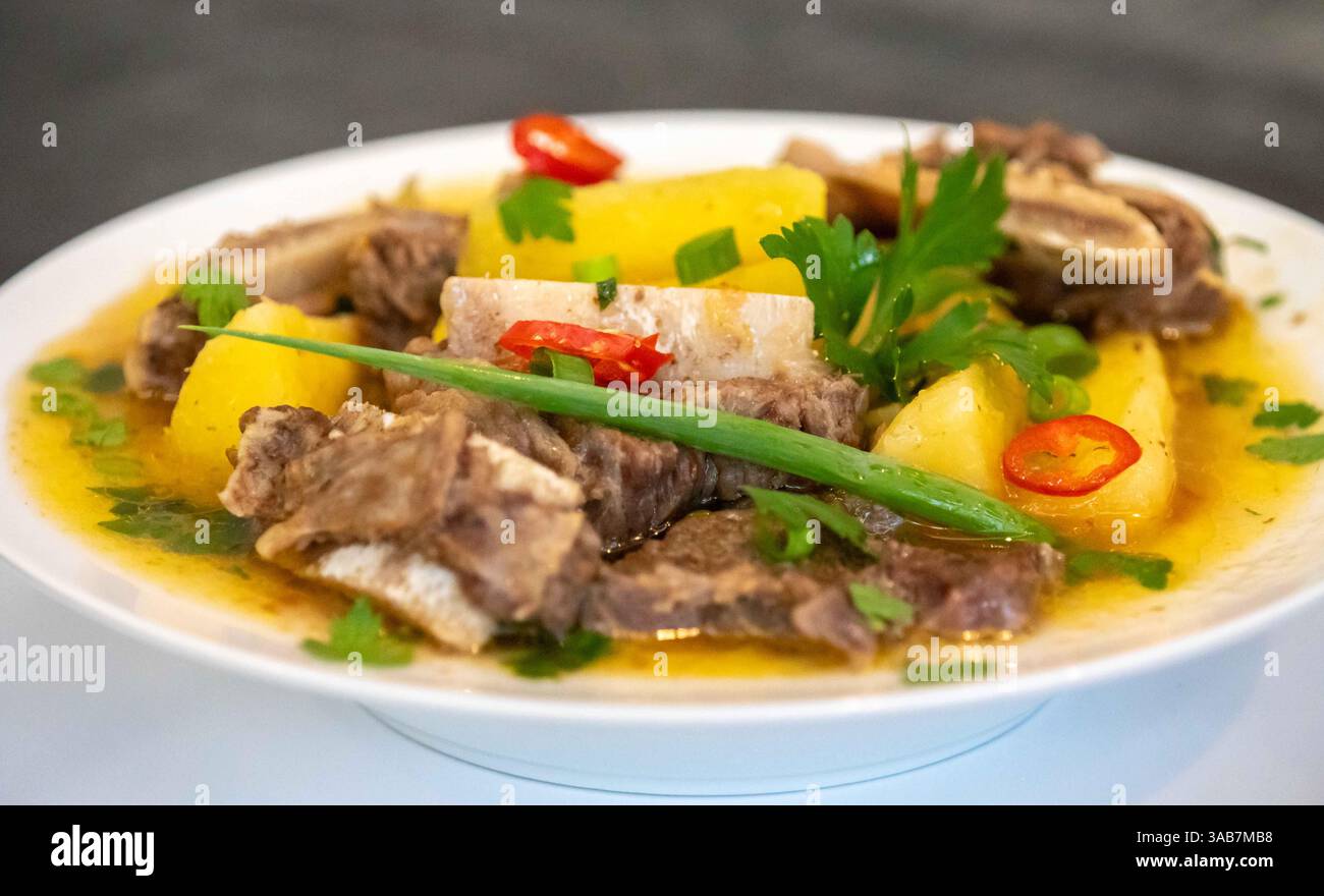 Traditional rustic Brazilian soup known as vaca atolada, prepared with ...