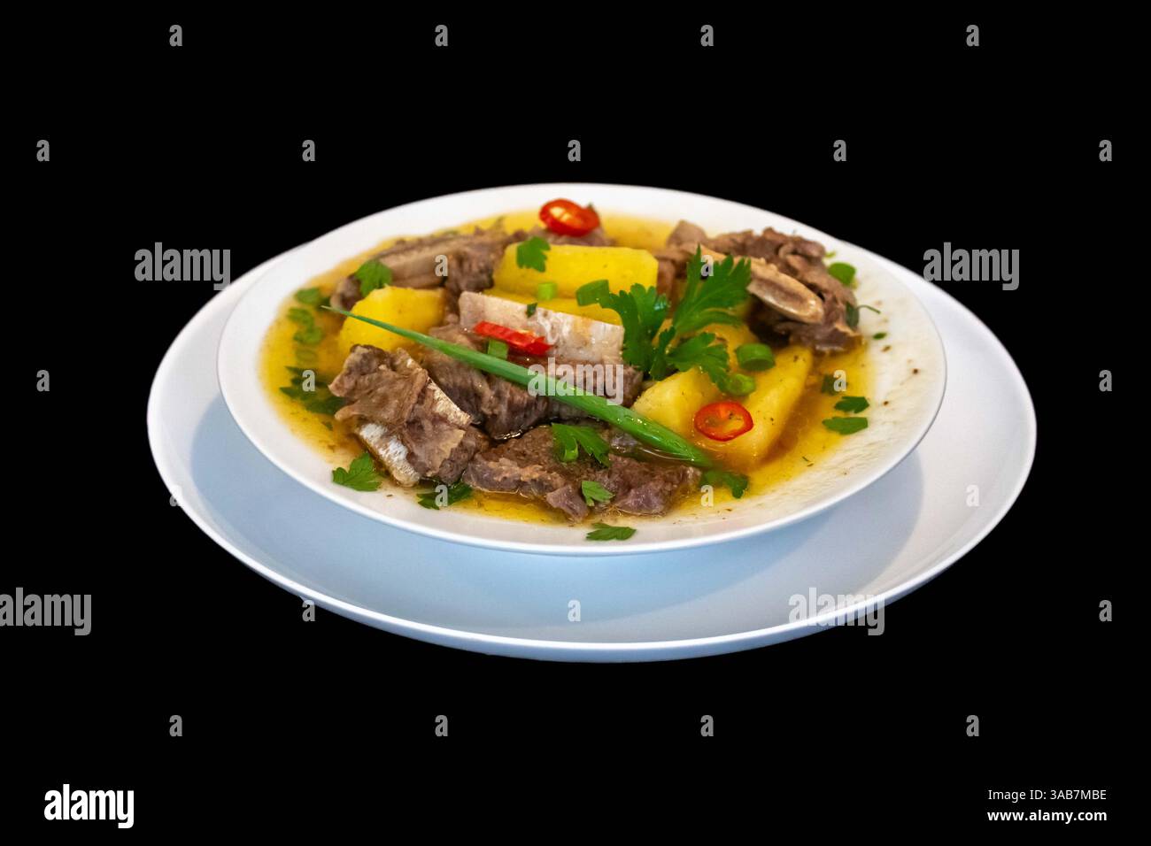 Traditional rustic Brazilian soup known as vaca atolada, prepared with ...