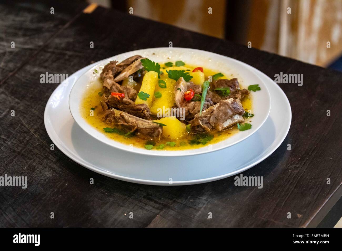 Traditional rustic Brazilian soup known as vaca atolada, prepared with ...