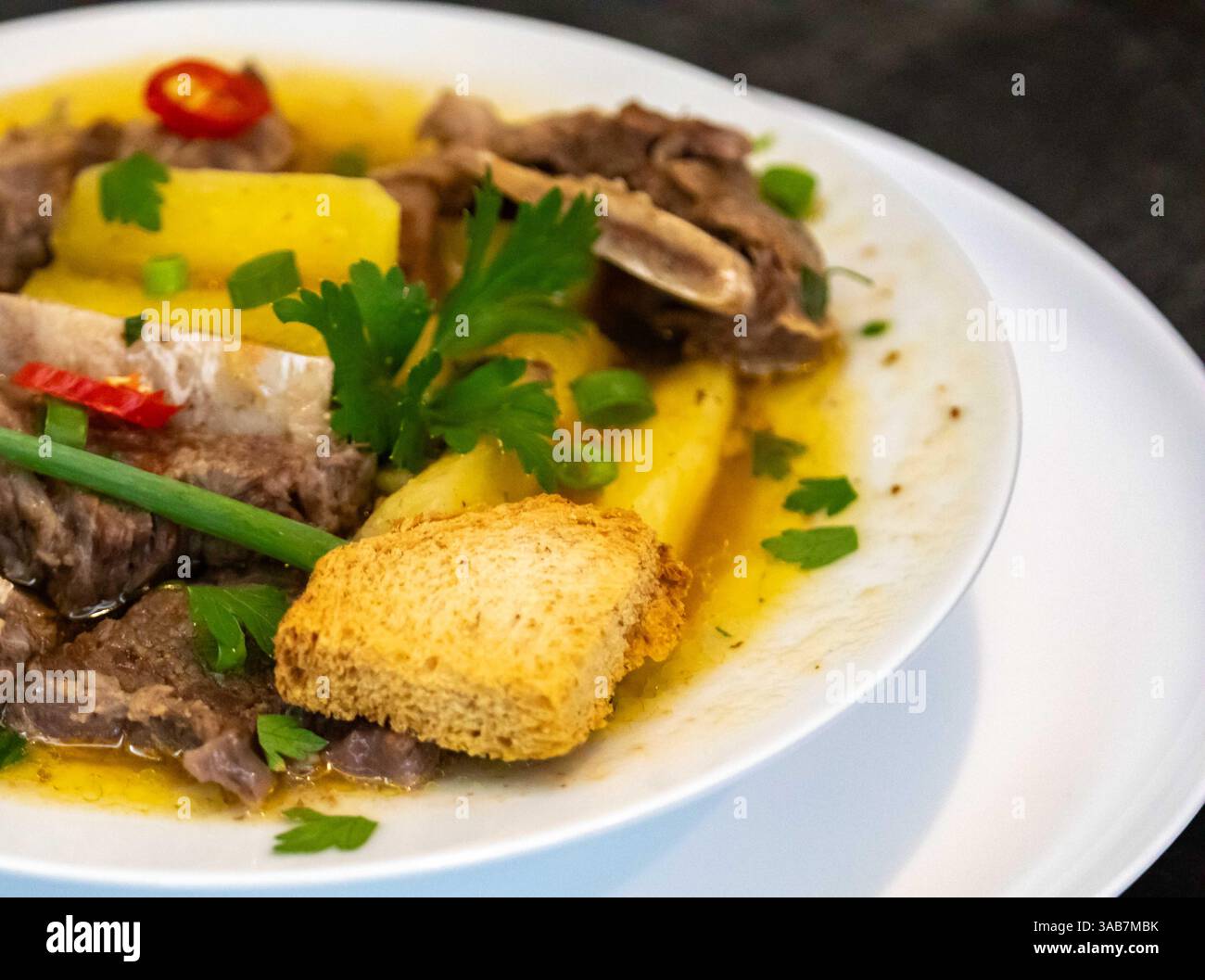 Traditional rustic Brazilian soup known as vaca atolada, prepared with ...