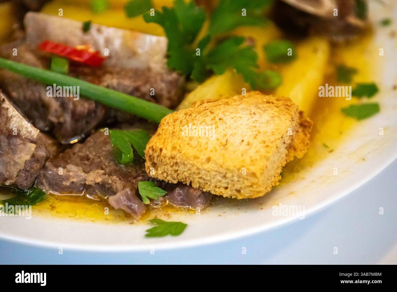 Traditional rustic Brazilian soup known as vaca atolada, prepared with ...