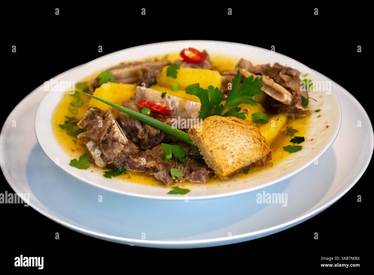 Traditional rustic Brazilian soup known as vaca atolada, prepared with ...