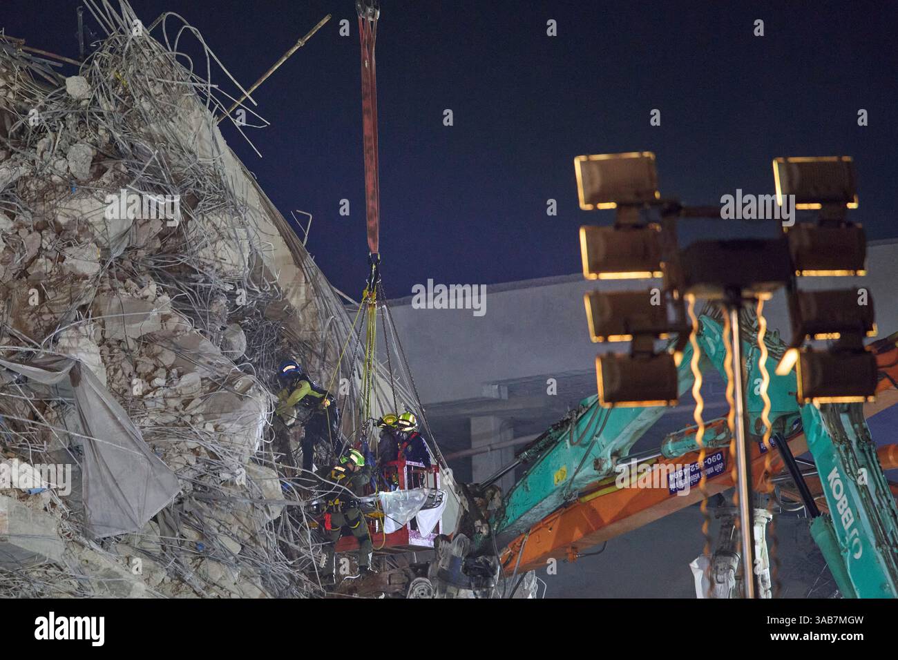 Rescuers take out a body of a worker from the rubbles of an under ...