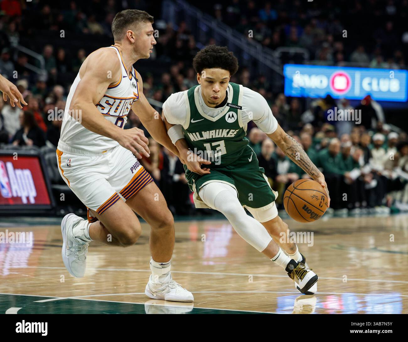 Milwaukee Bucks' Ryan Rollins (13) drives against the Phoenix Suns ...