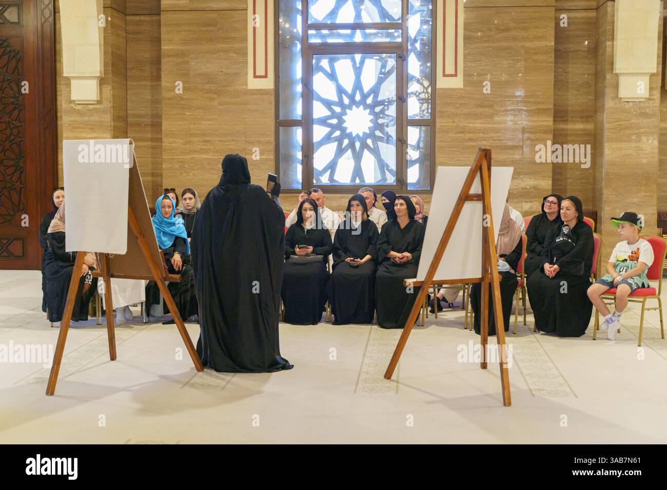 Manama, Bahrain - Jan 15 2024, An Arab woman dressed in a black burqa ...