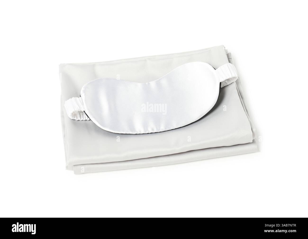 Silky bed linens and sleeping mask on white background Stock Photo - Alamy