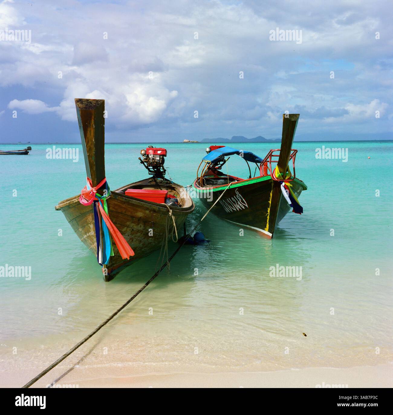 Longtail boats rest on serene hi-res stock photography and images - Alamy
