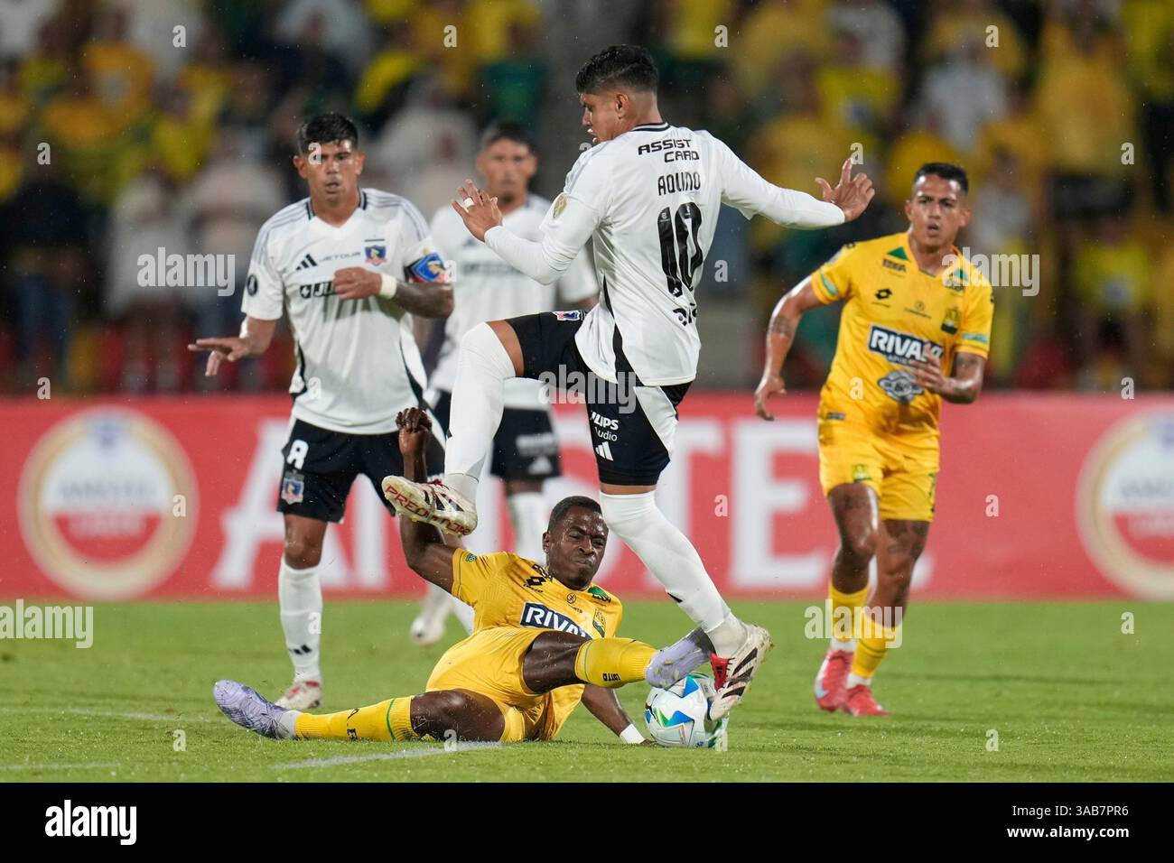 Claudio Aquino of Chile's Colo Colo, top, and Edwin Castro of Colombia ...