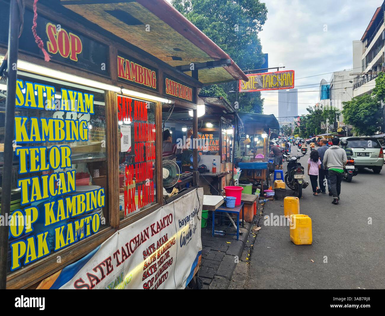 Street food carts and vendors on the roadside in downtown Jakarta ...