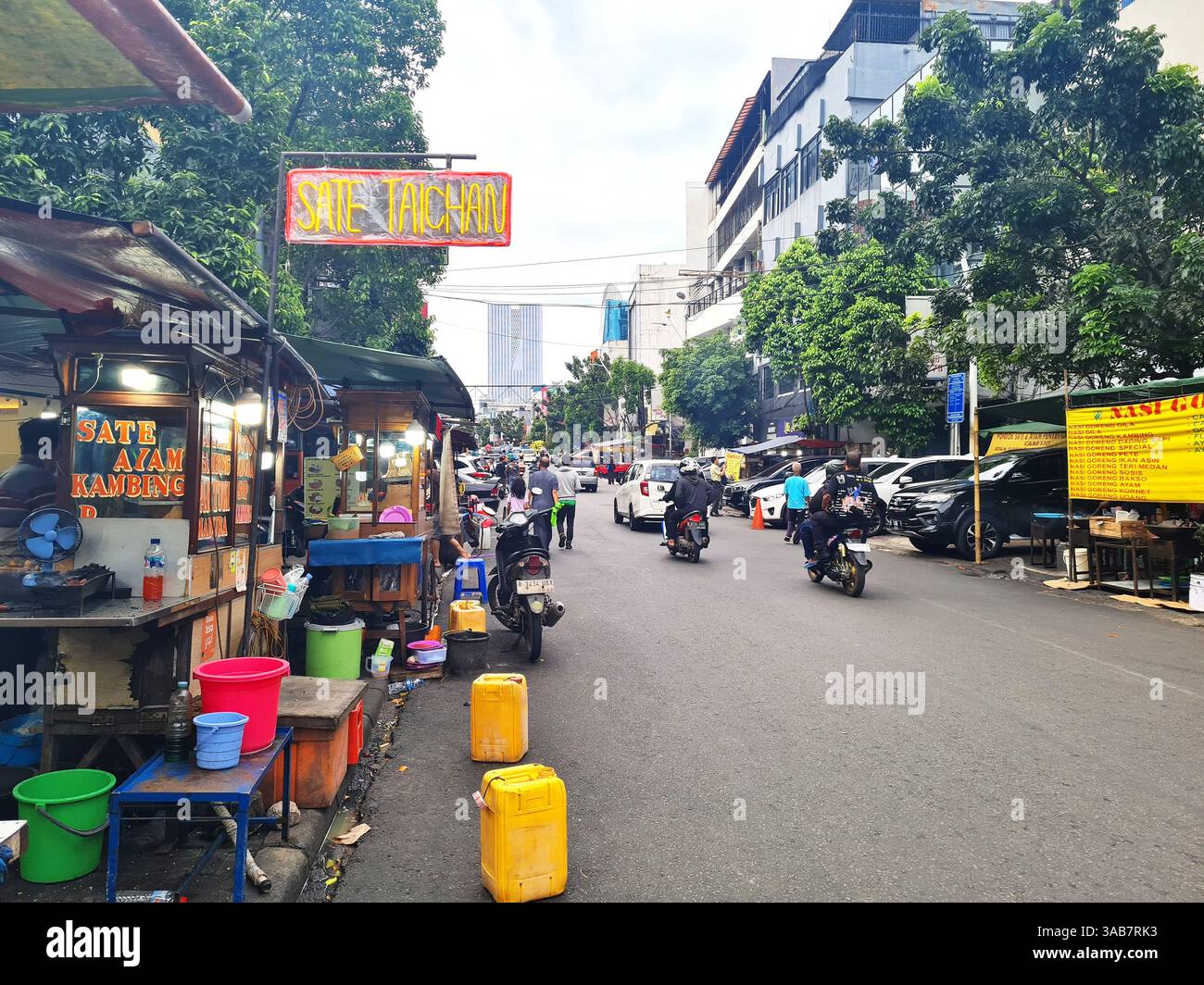 Street food carts and vendors on the roadside in downtown Jakarta ...