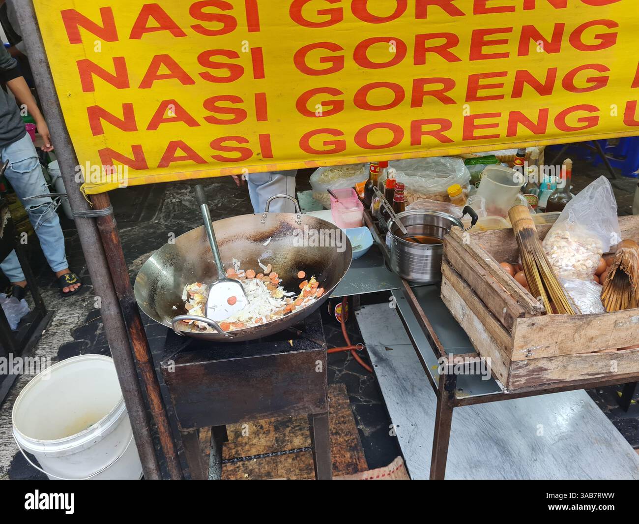 Street food vendor cooking Indonesian street food on the roadside in ...