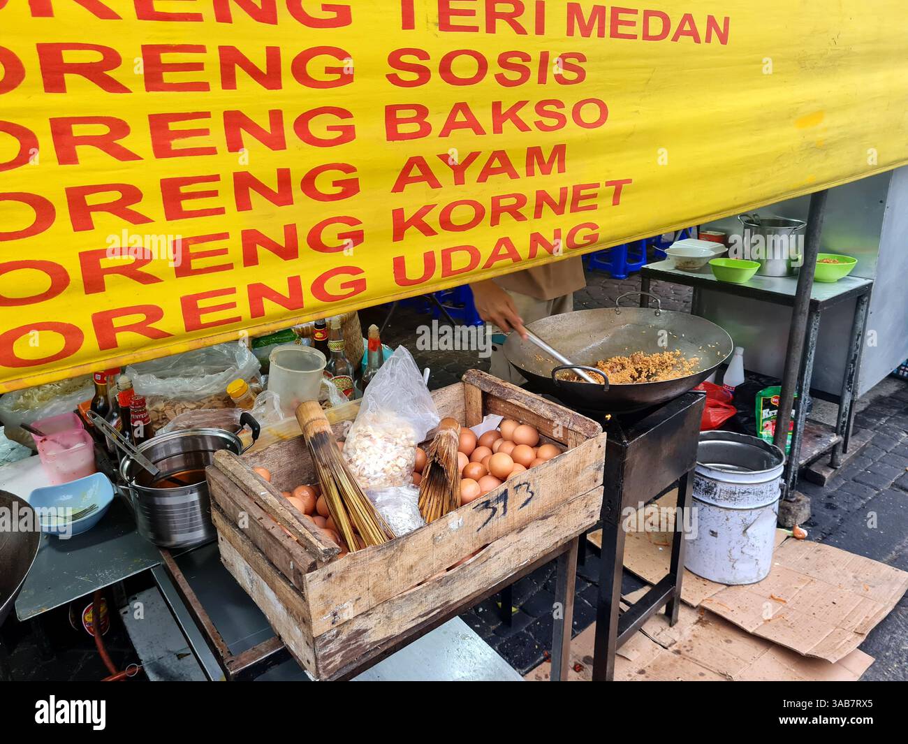 Street food vendor cooking nasi goreng fried rice on the roadside in ...