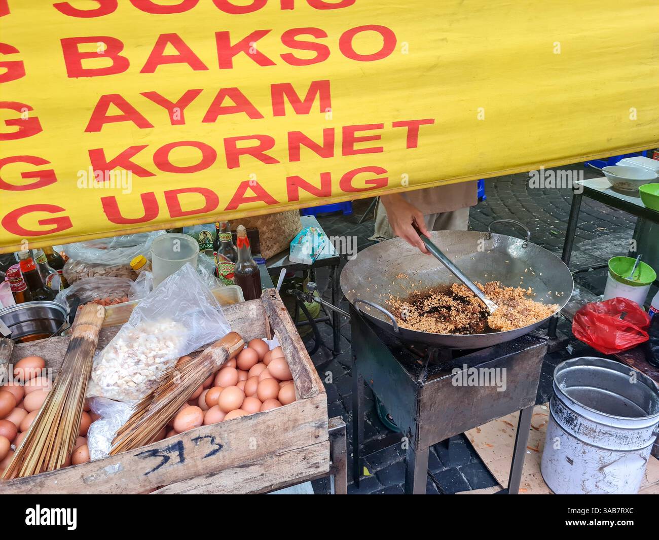 Street food vendor cooking nasi goreng fried rice on the roadside in ...