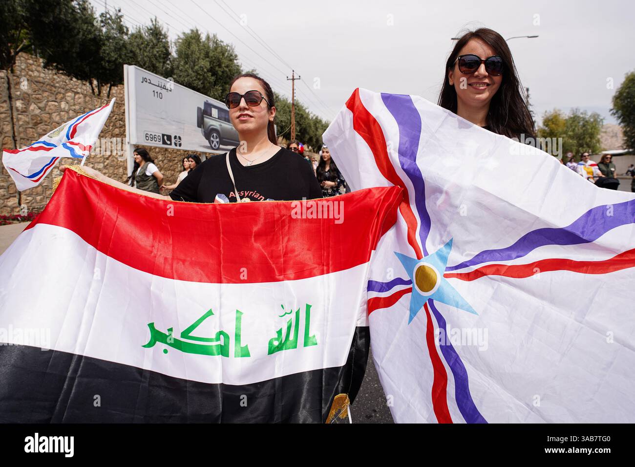 Assyrians dressed in traditional clothes march to the tunes of a ...