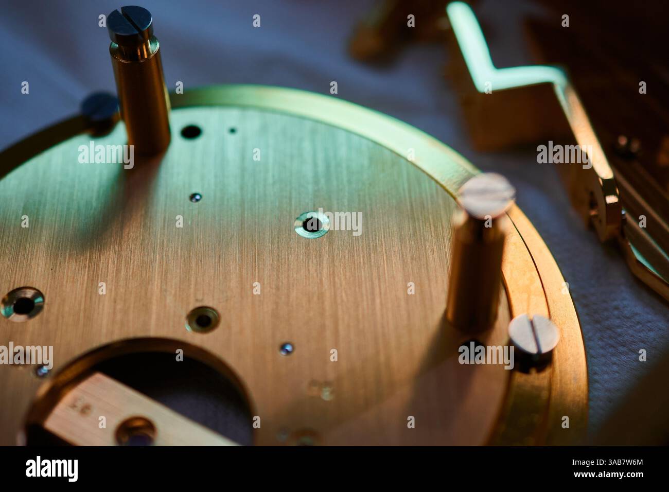 Intricate craftsmanship of watch mechanism bases being assembled in a ...