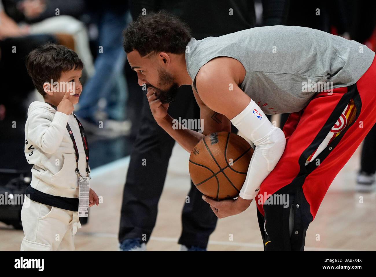 Atlanta Hawks guard Trae Young speaks with his son, Tydus Reign Young ...